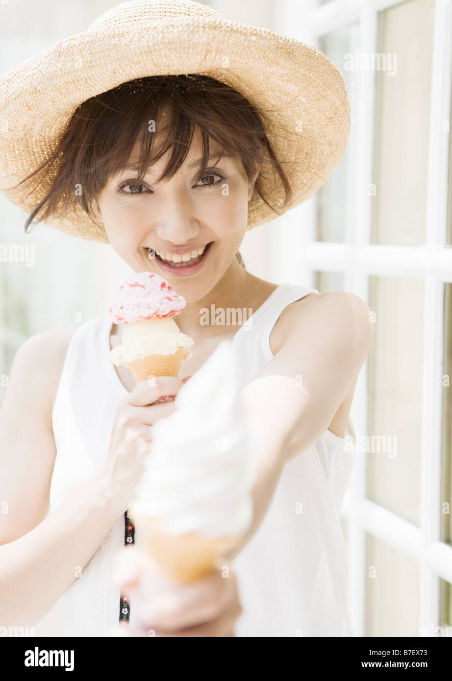 A woman giving ice cream Stock Photo - Alamy