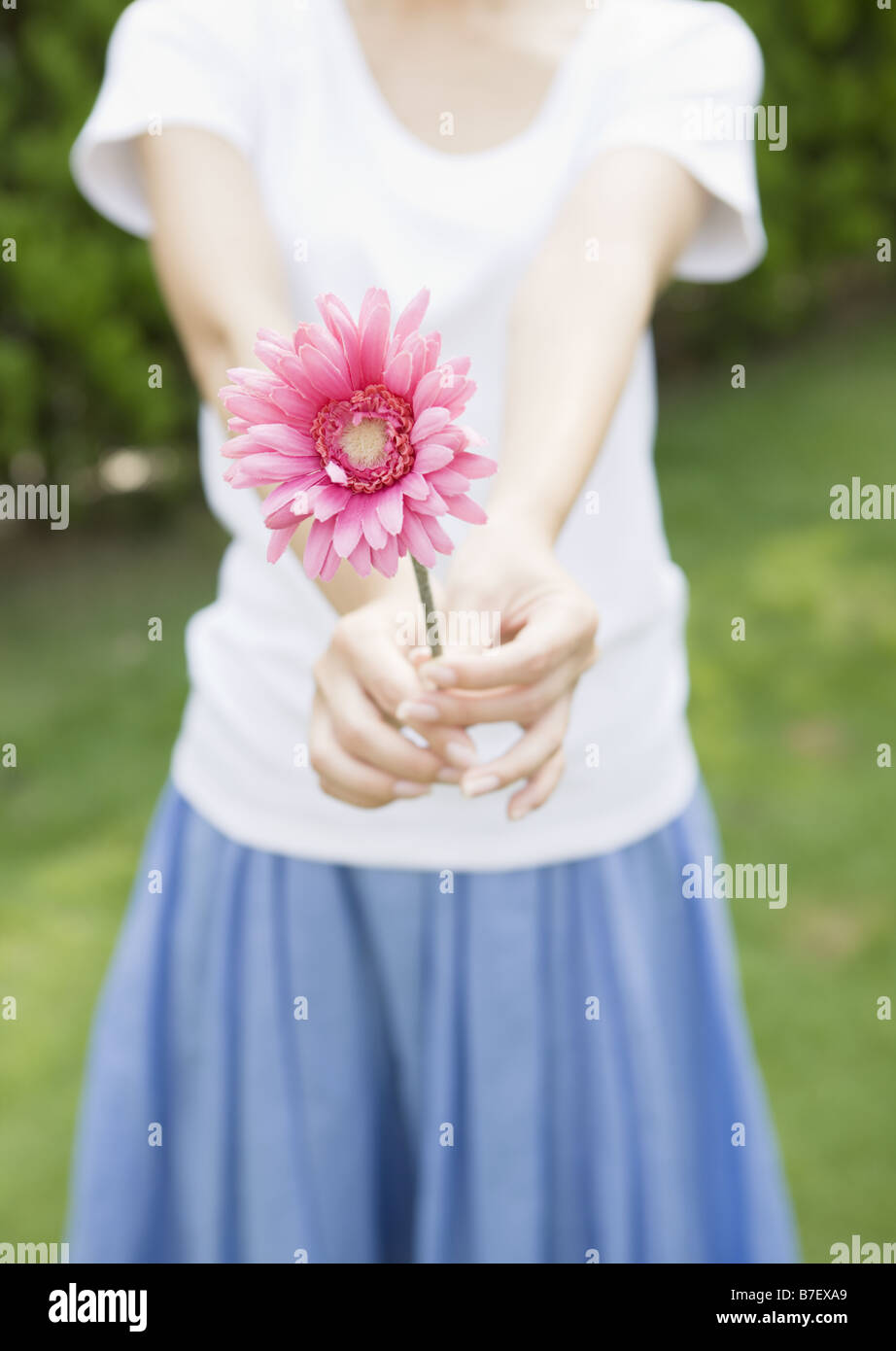 A woman giving flowers Stock Photo - Alamy