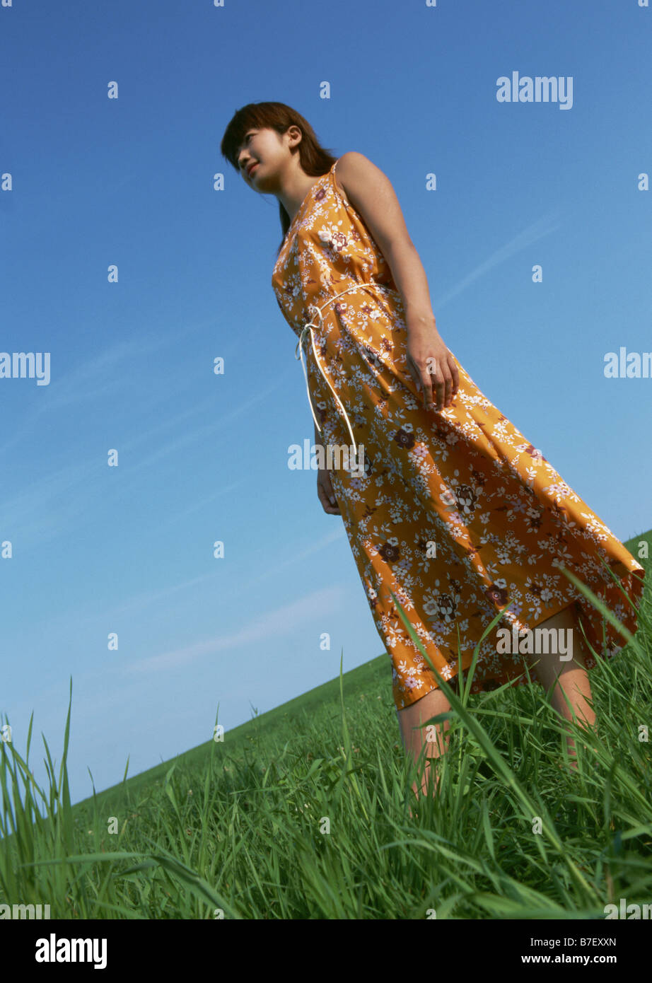Woman standing in field Stock Photo - Alamy