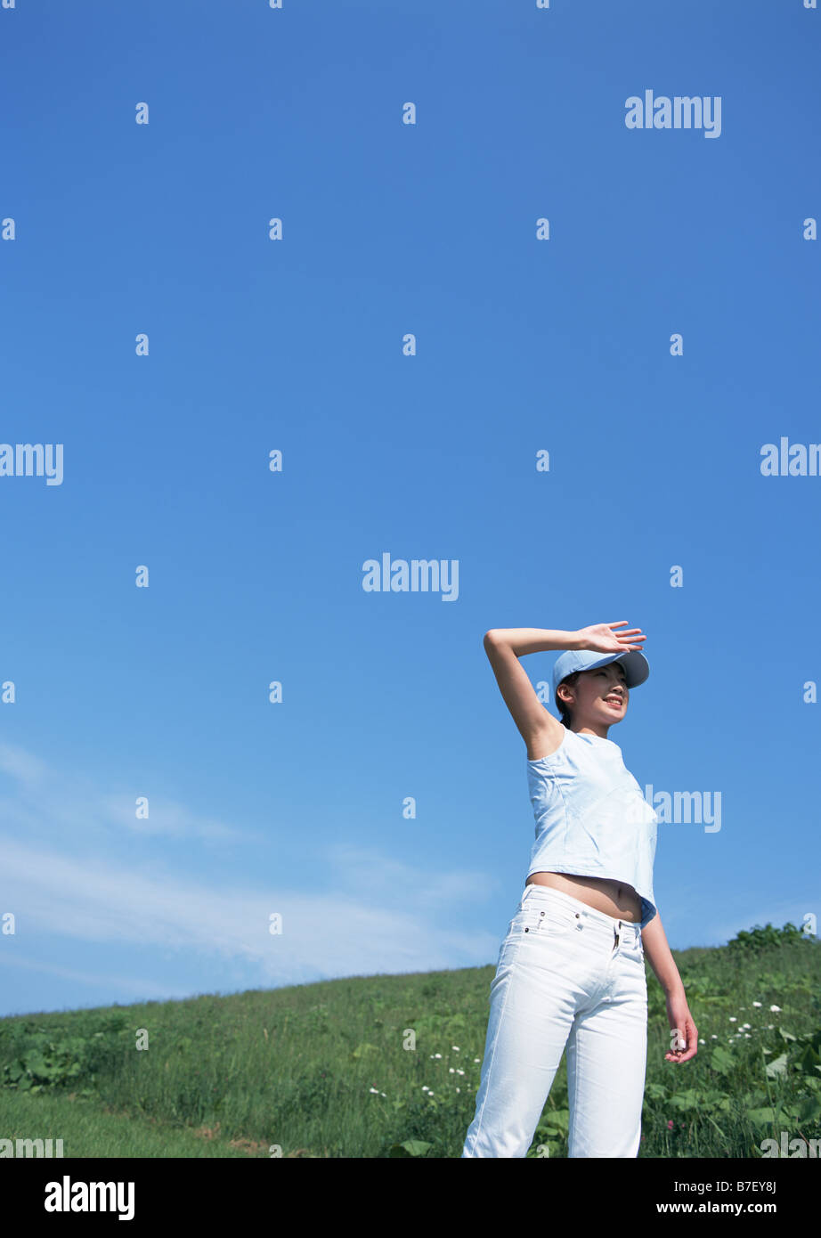 Woman standing in field Stock Photo - Alamy