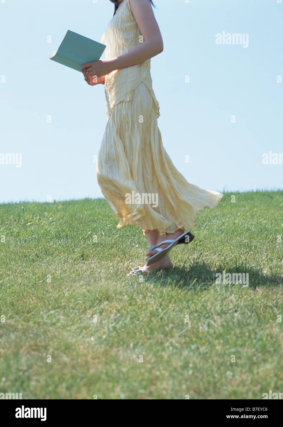 Woman reading in field Stock Photo - Alamy