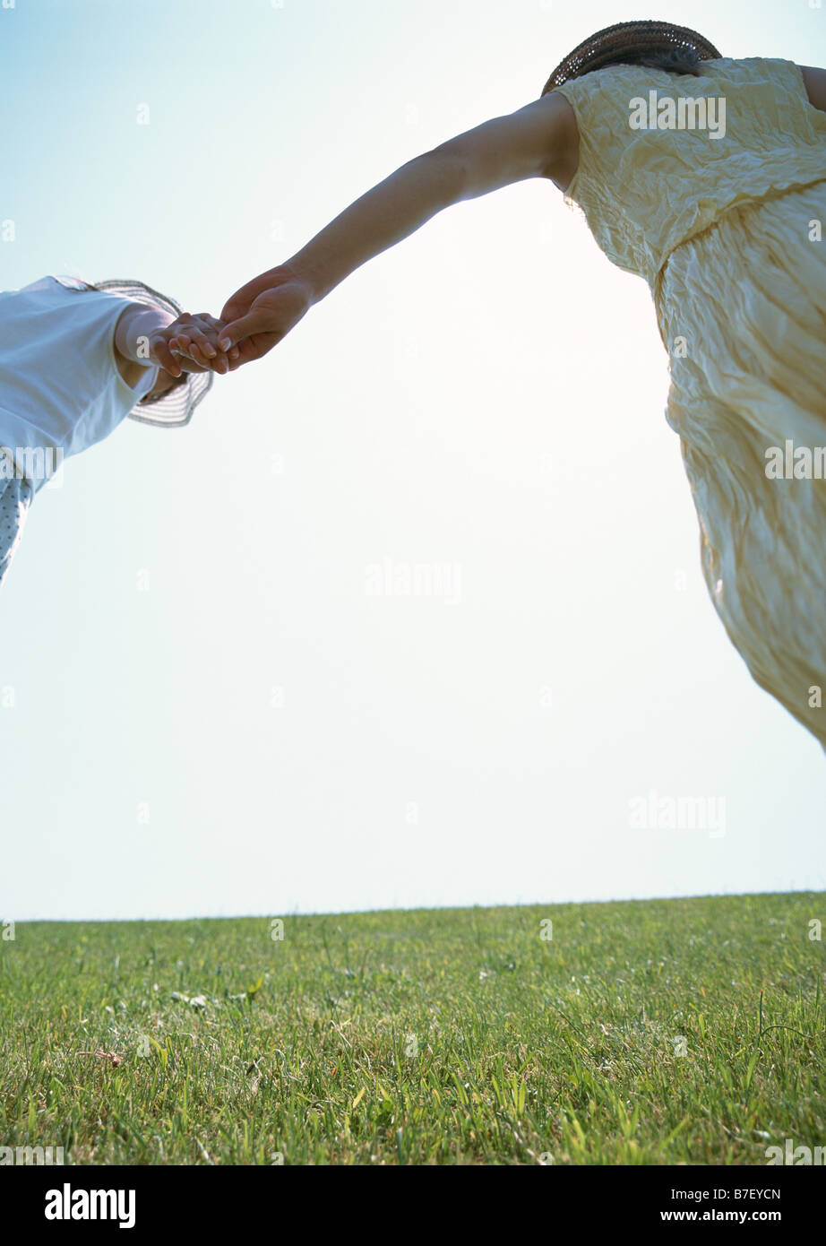 Women walking hand in hand Stock Photo - Alamy