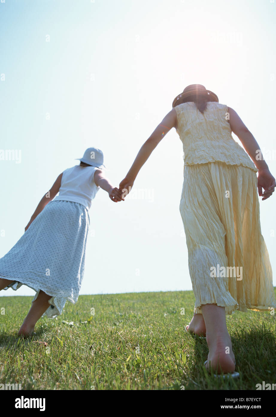 Women walking hand in hand Stock Photo - Alamy