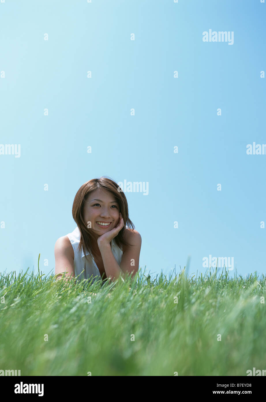 Relaxed woman smiling in field Stock Photo - Alamy