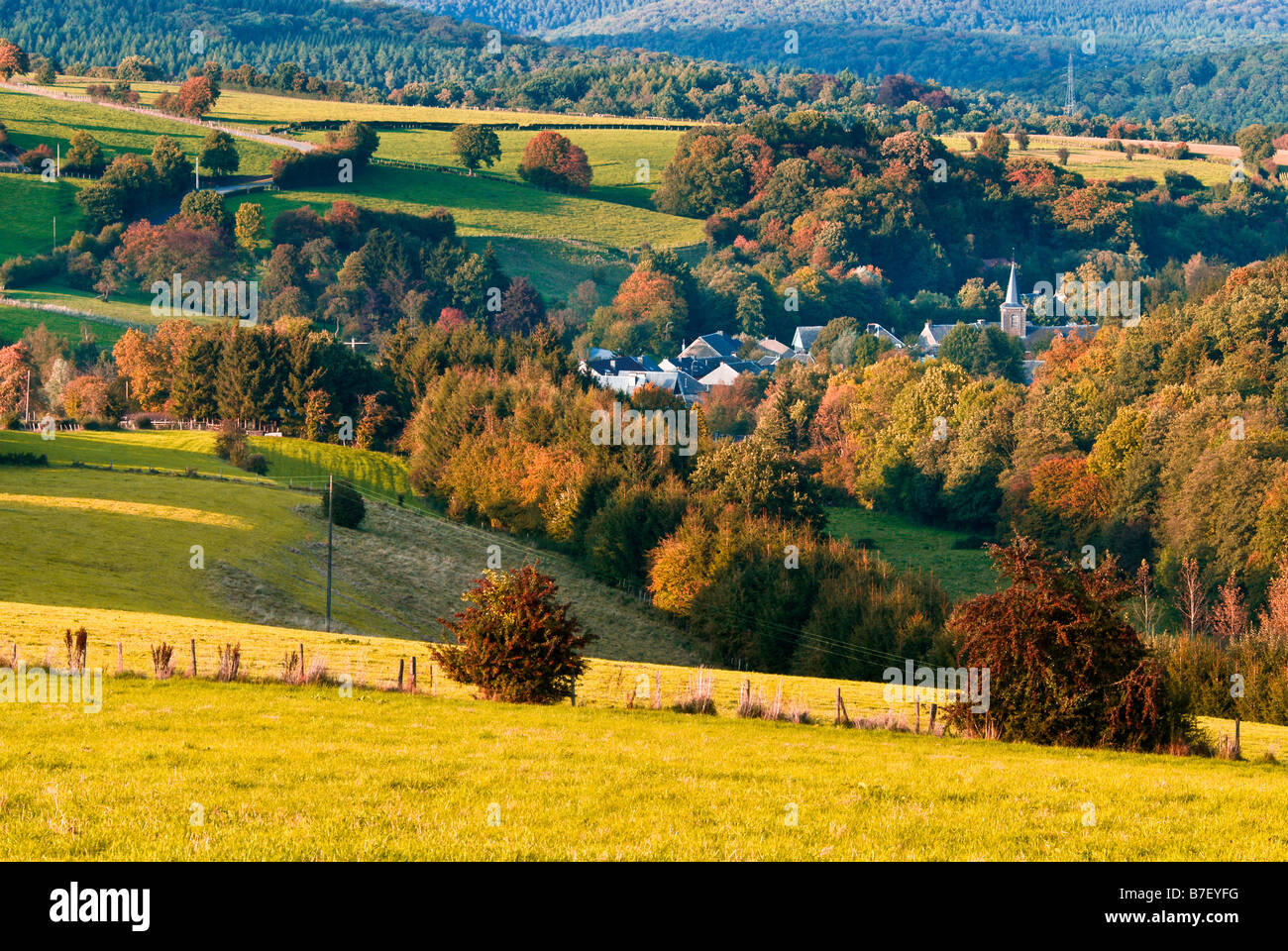 beautiful autumn landscape with little village surrounded by trees ...