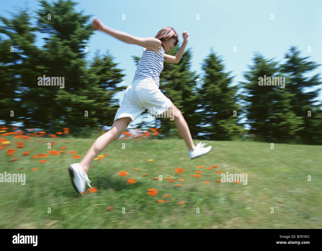 Woman jumping up in field Stock Photo - Alamy