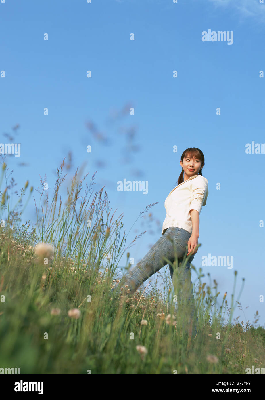 Woman walking in field Stock Photo - Alamy
