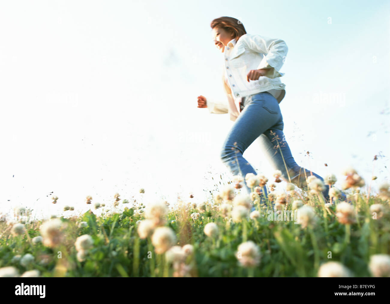 Woman running in field Stock Photo - Alamy