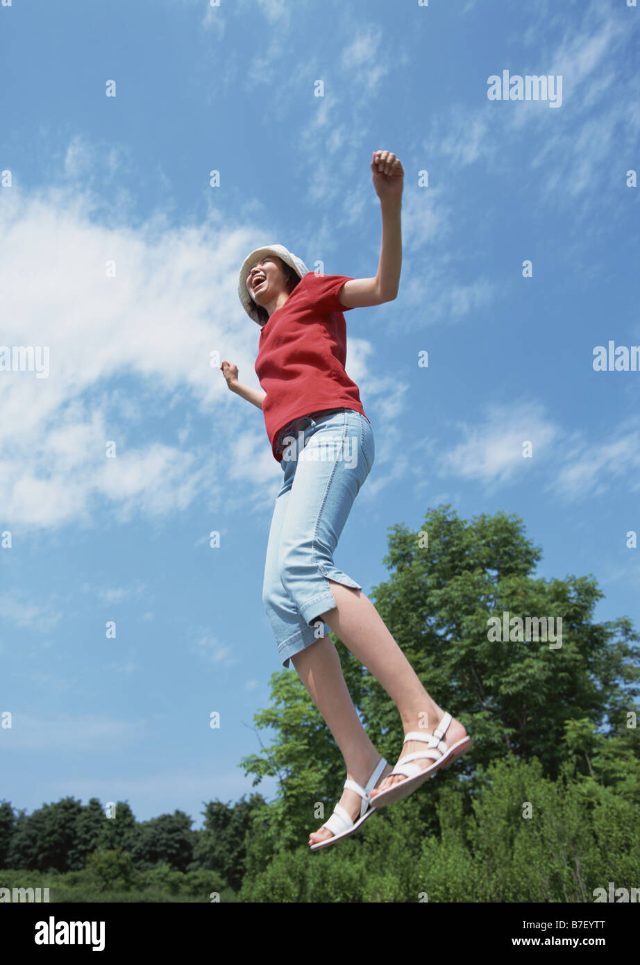 Young woman jumping around Stock Photo - Alamy