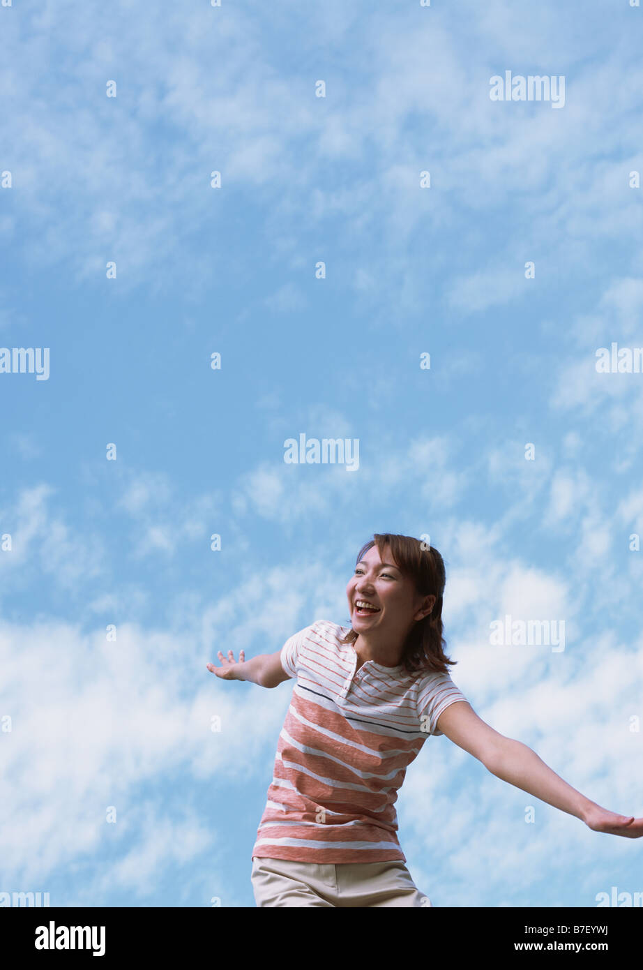 Woman and blue sky Stock Photo - Alamy