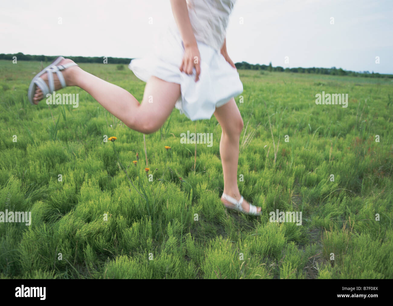 Woman running in field Stock Photo - Alamy