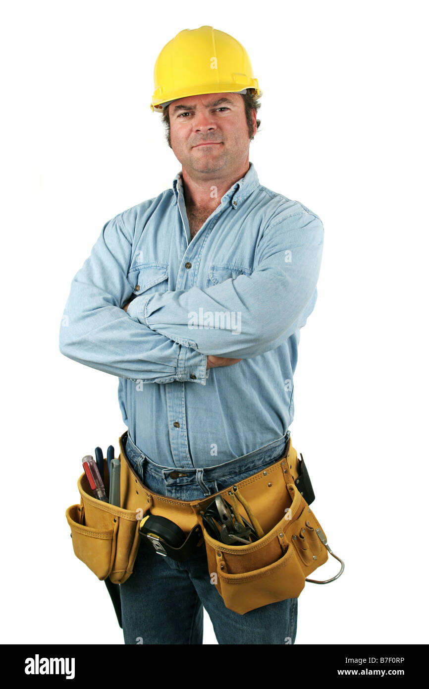 A handsome construction worker wearing a hard hat and tool belt and ...