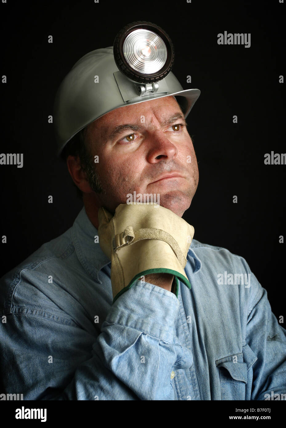 A portrait of a coal miner who s dirty face reflects years of hard work ...