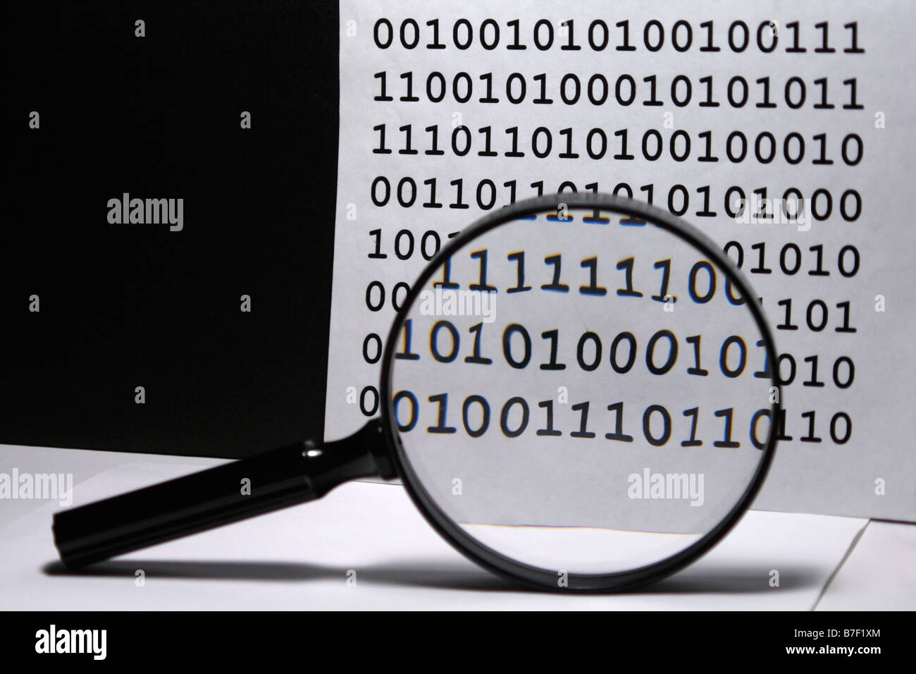 Magnifying glass on binary background Stock Photo - Alamy