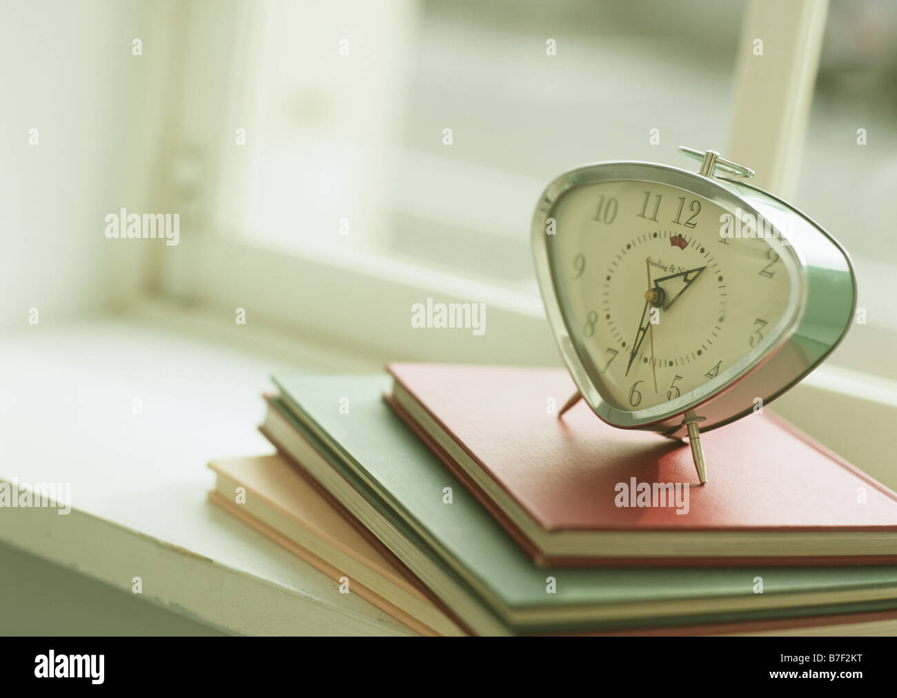 Books and alarm clock Stock Photo - Alamy
