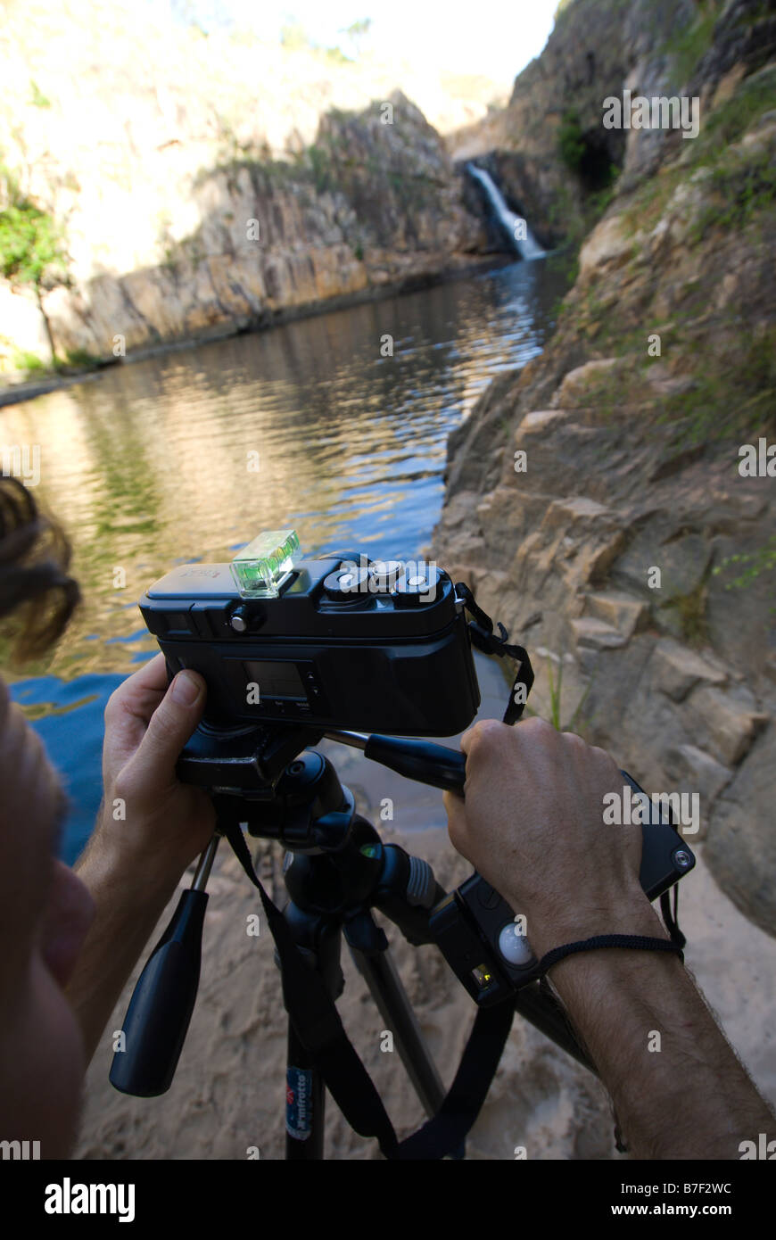 Man photographing Maguk Waterfall and plunge pool in Kakadu National ...