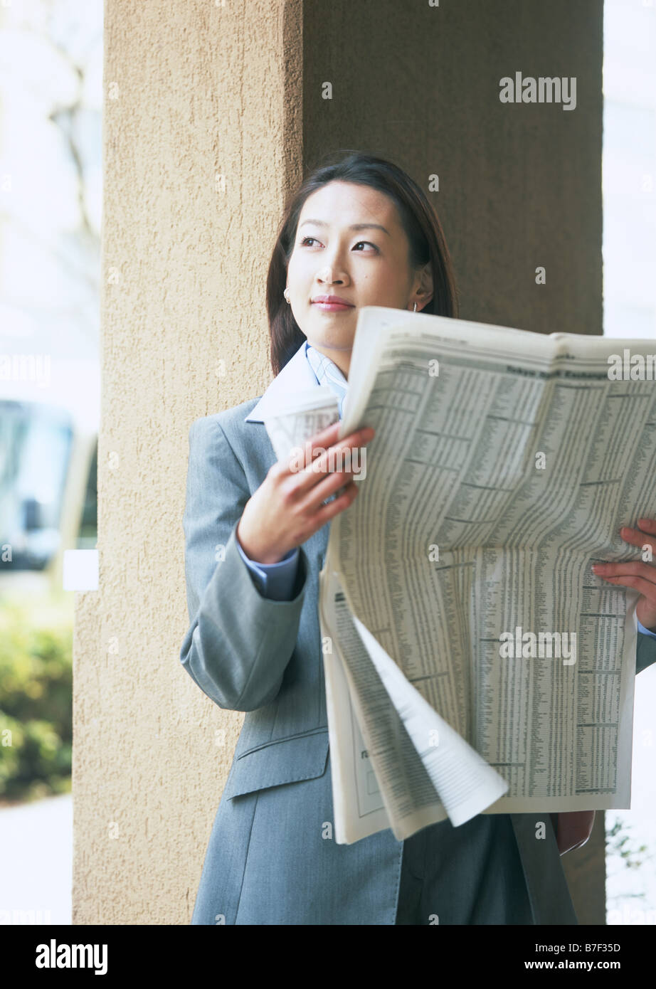 Business woman reading newspaper Stock Photo - Alamy