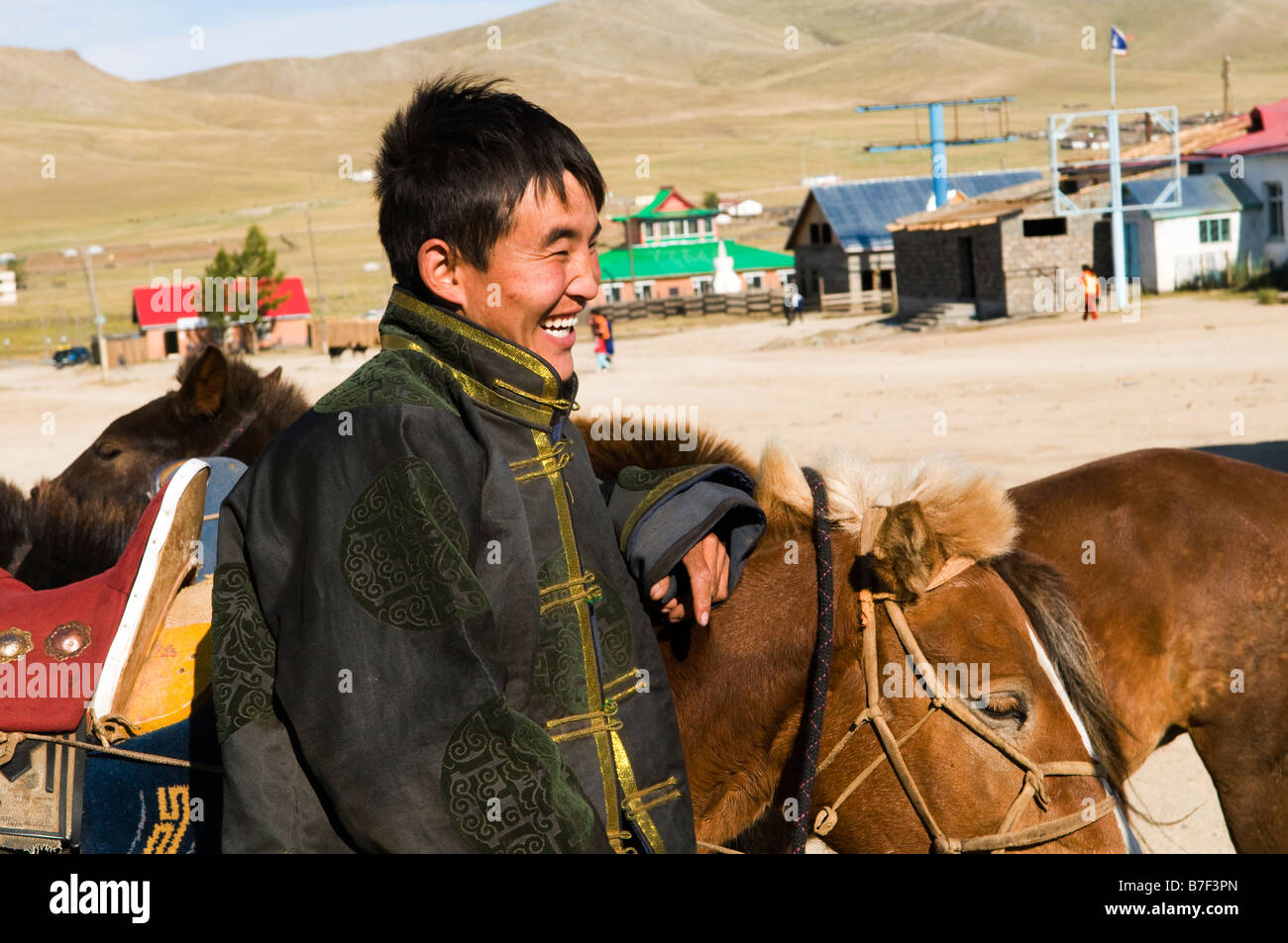 A Mongol visits a local market with his horses Stock Photo - Alamy