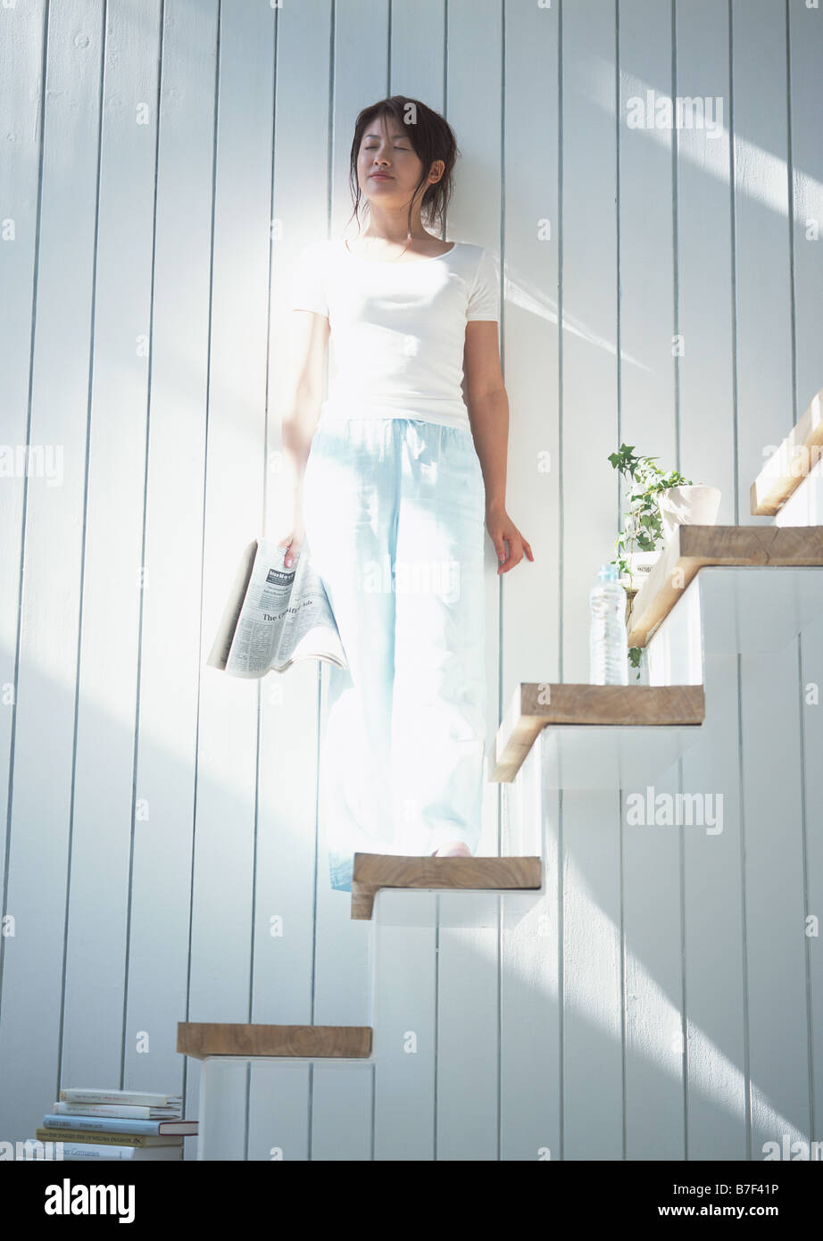 Woman standing on stairs Stock Photo - Alamy