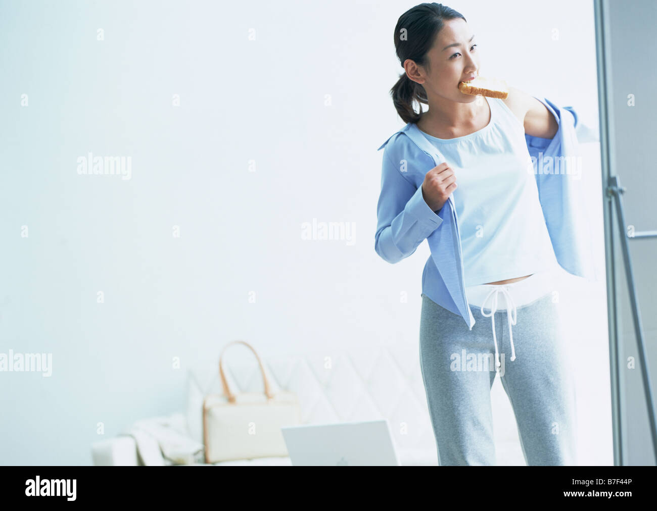 Woman getting dressed Stock Photo - Alamy