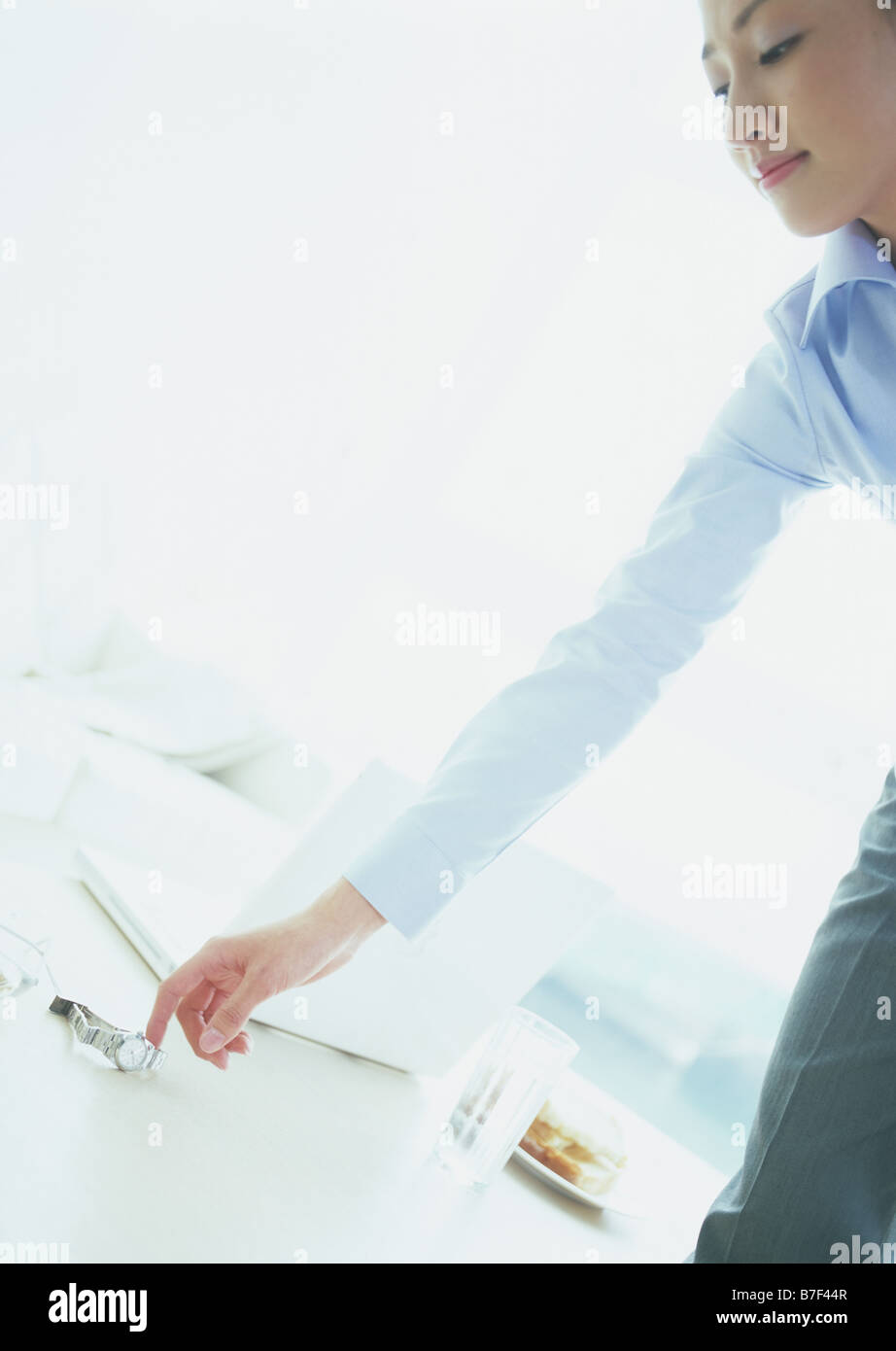 Woman taking a watch Stock Photo - Alamy