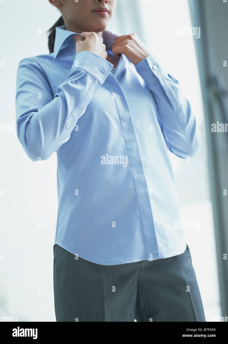 Woman getting dressed Stock Photo - Alamy