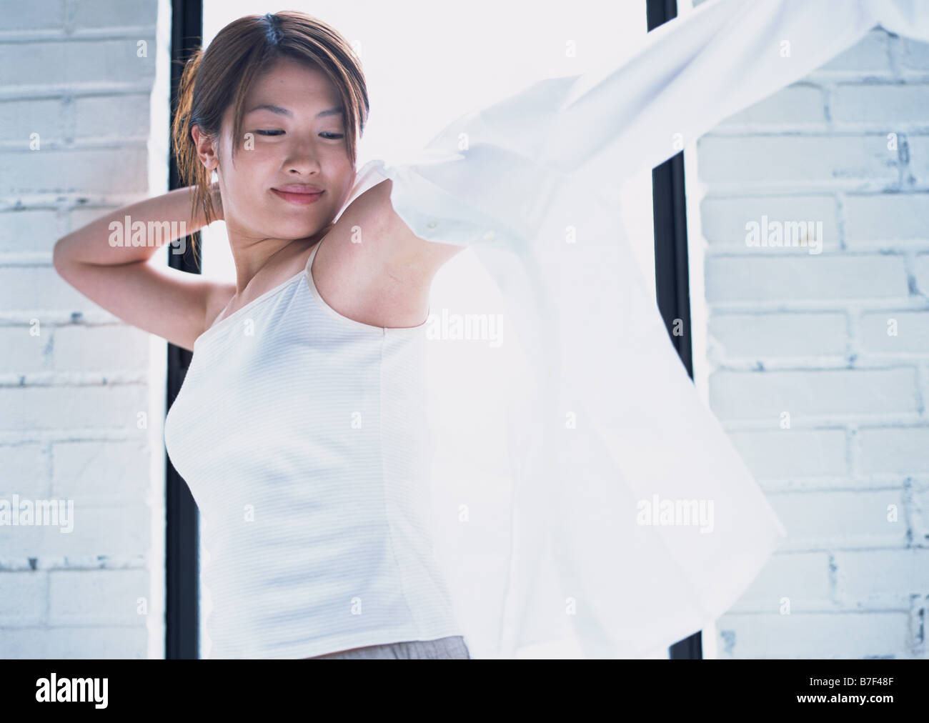 Woman getting dressed Stock Photo - Alamy