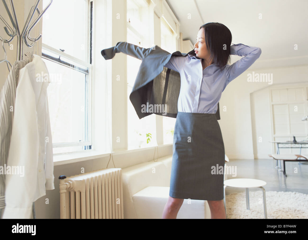 Woman getting dressed Stock Photo - Alamy