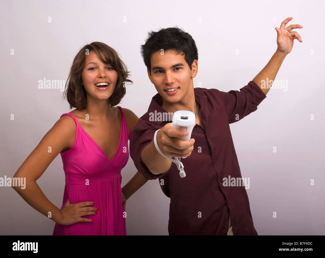 Two Asian American siblings playing a video game Stock Photo - Alamy