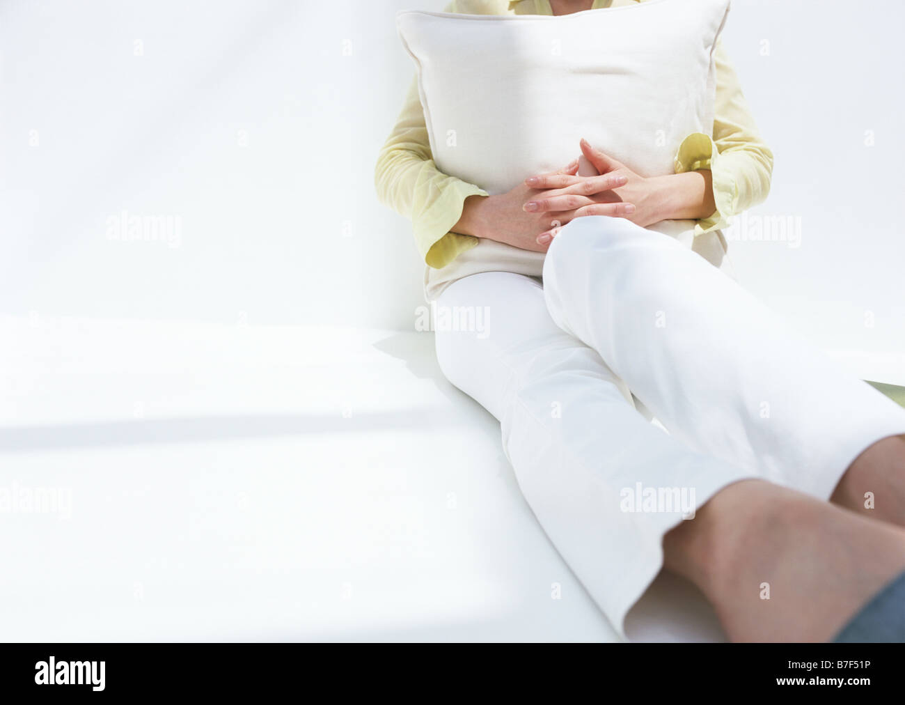 Woman clutching cushion Stock Photo - Alamy