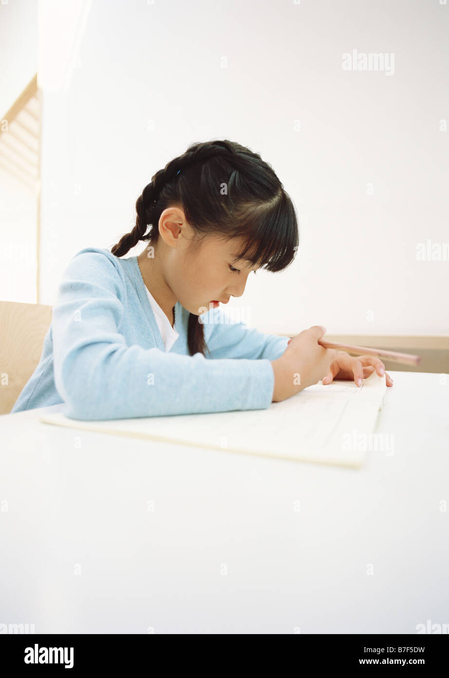 Girl doing homework Stock Photo - Alamy