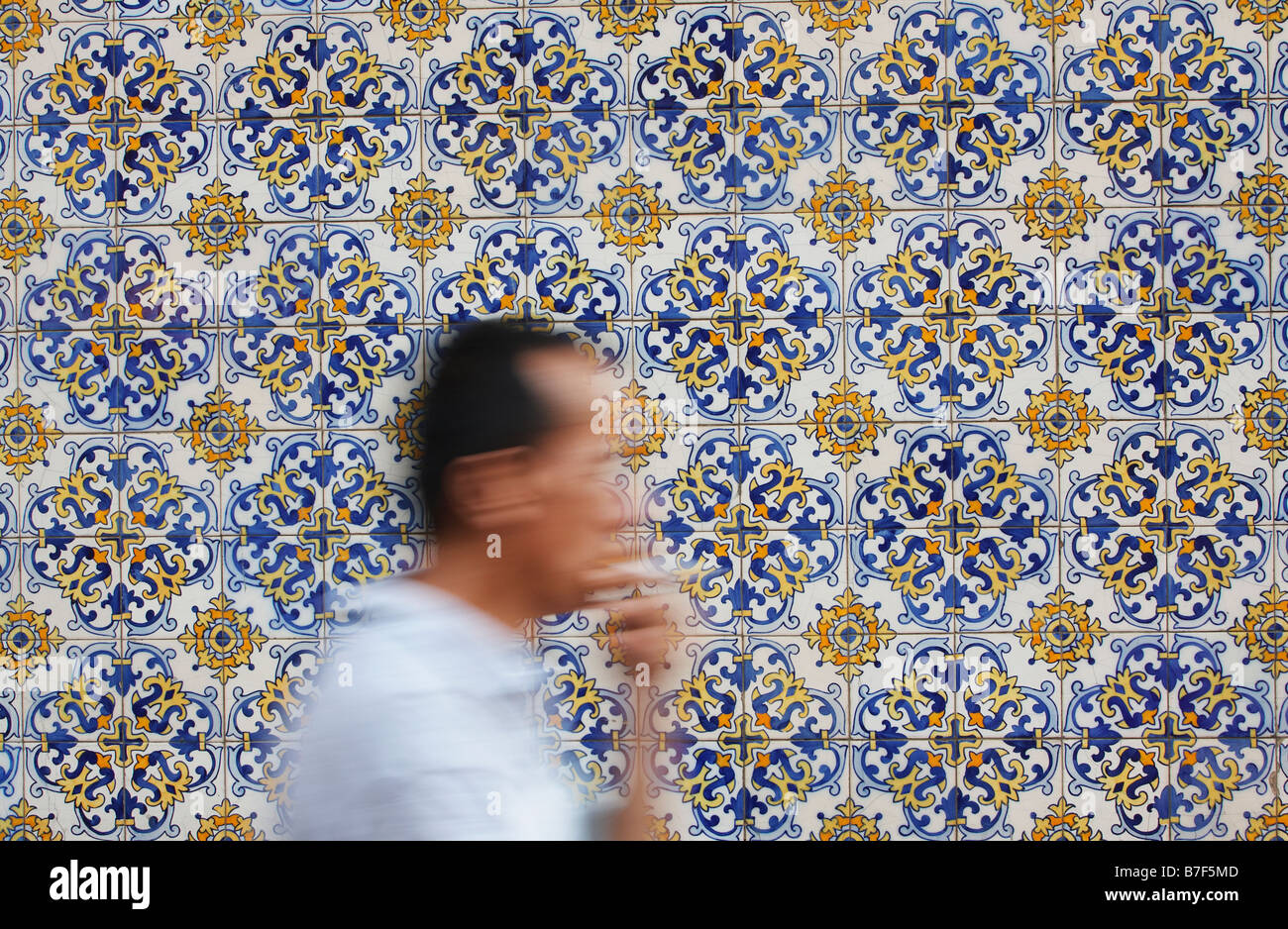 Man Walking Past Colourful Tiles In Street, Macau Stock Photo - Alamy