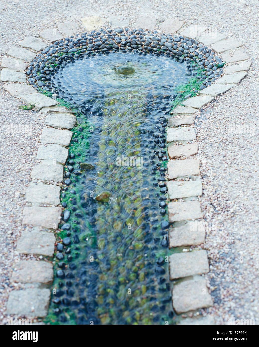 WATER FEATURE USING VARIOUS STONE TYPES SET IN CEMENT Stock Photo - Alamy