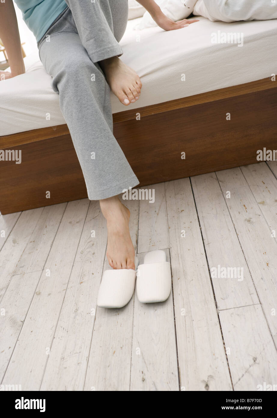 Woman slippered on bed Stock Photo - Alamy