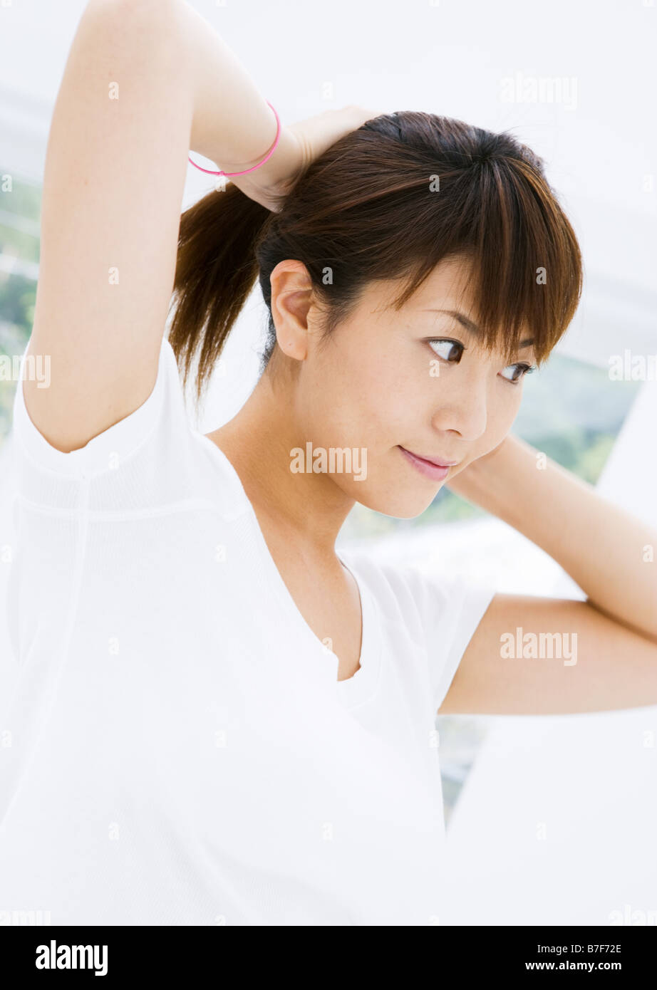 Woman catching up hair Stock Photo - Alamy