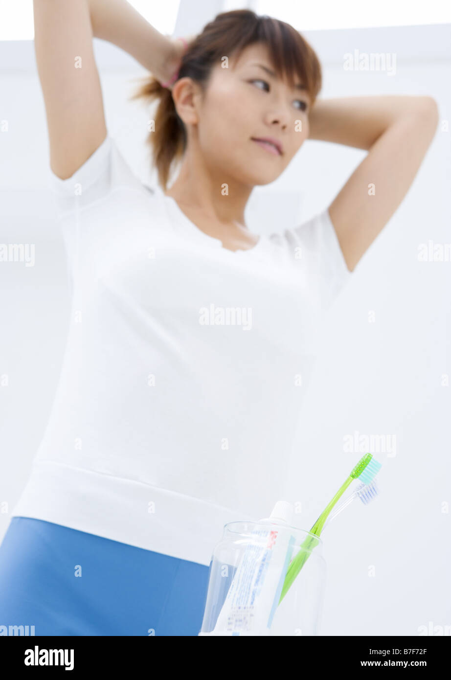 Woman catching up hair Stock Photo - Alamy