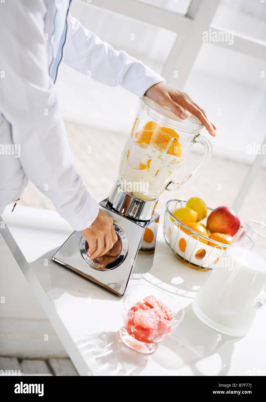 Woman making fruits juice Stock Photo - Alamy