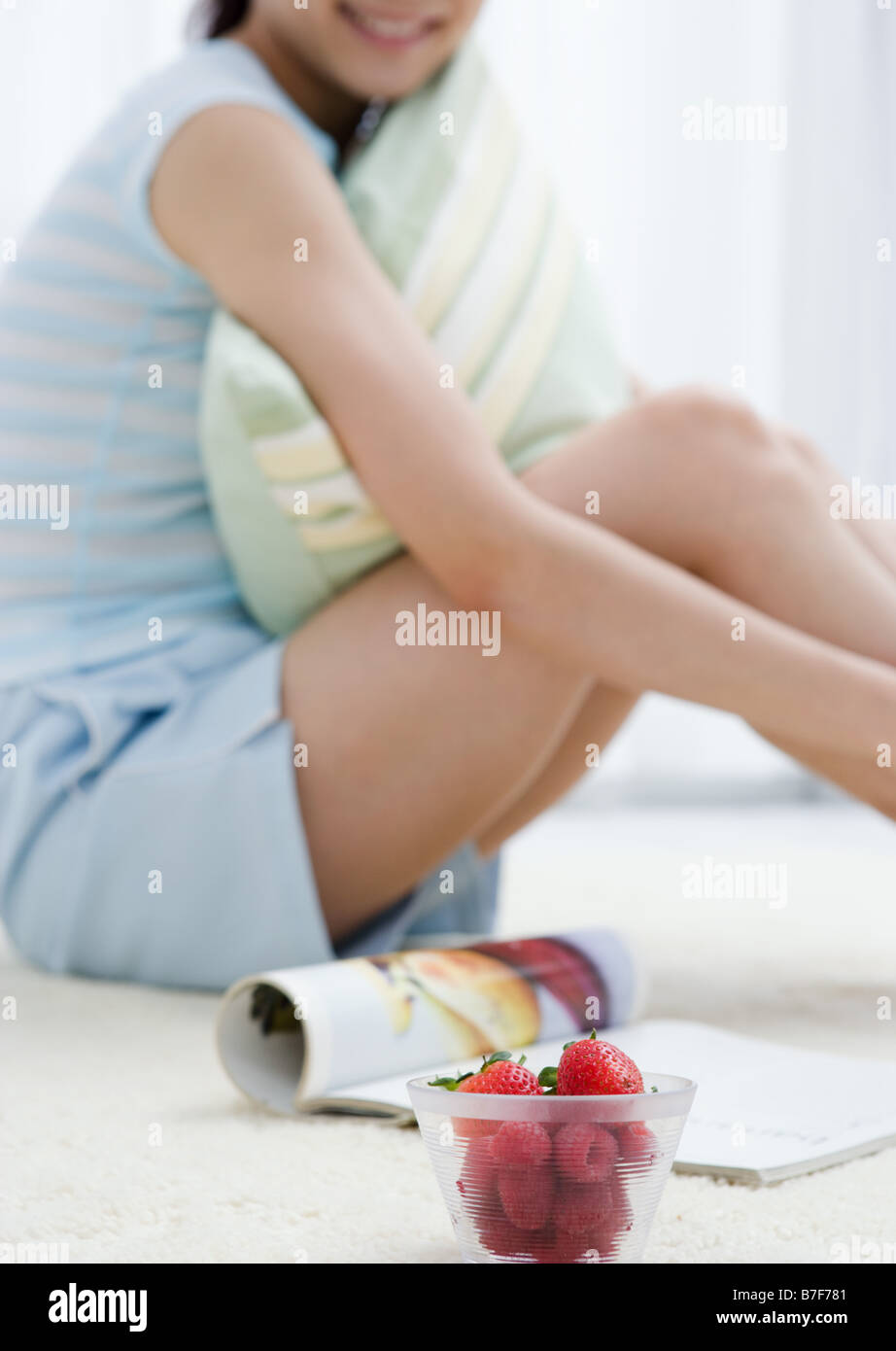 Woman clutching cushion Stock Photo - Alamy