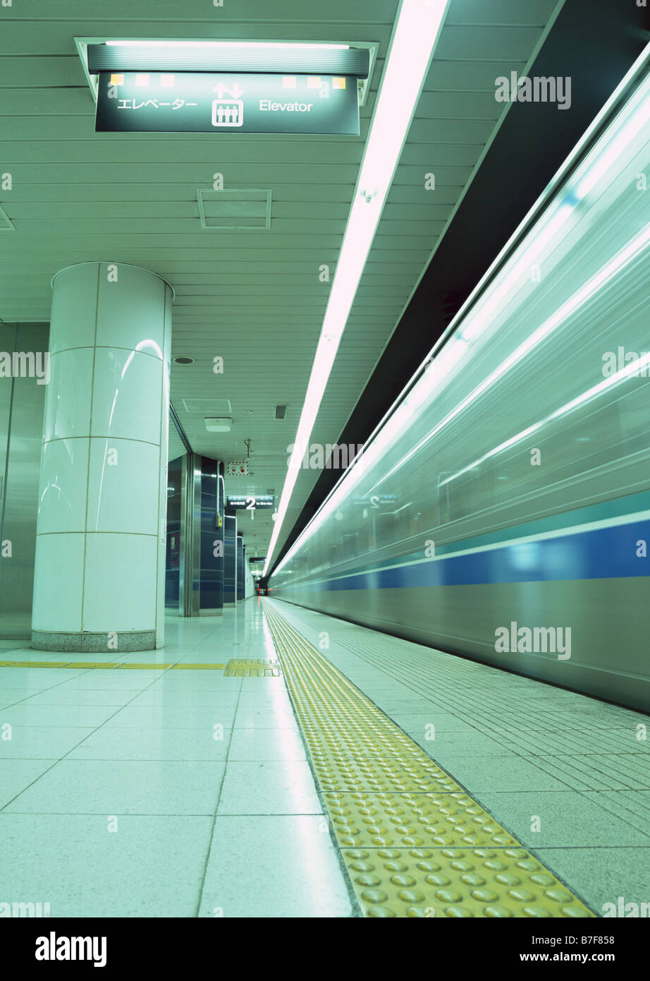 Subway passing through station Stock Photo - Alamy