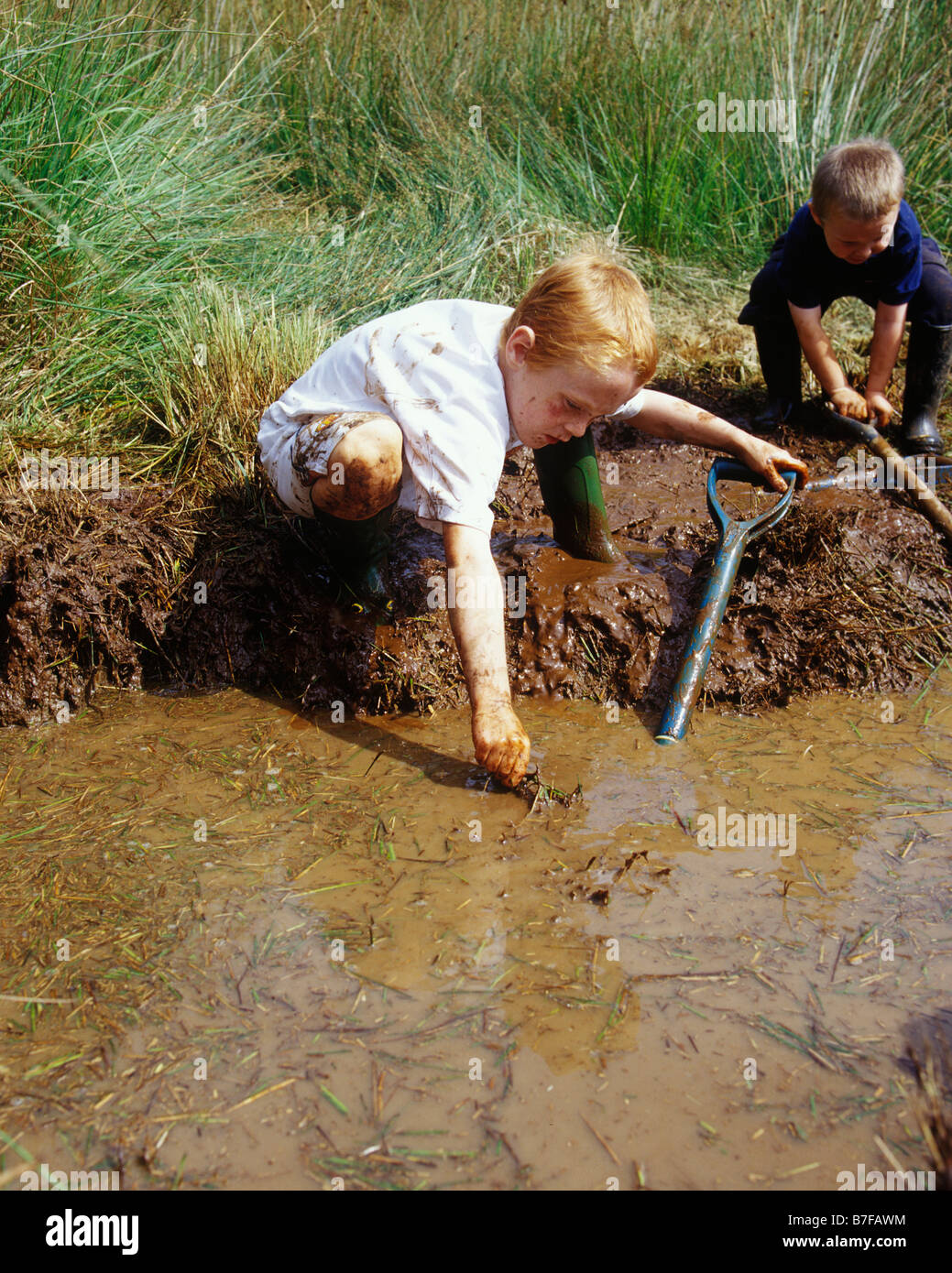 DIGGING A WILDLIFE POND USING YOUNG HELPERS Stock Photo - Alamy