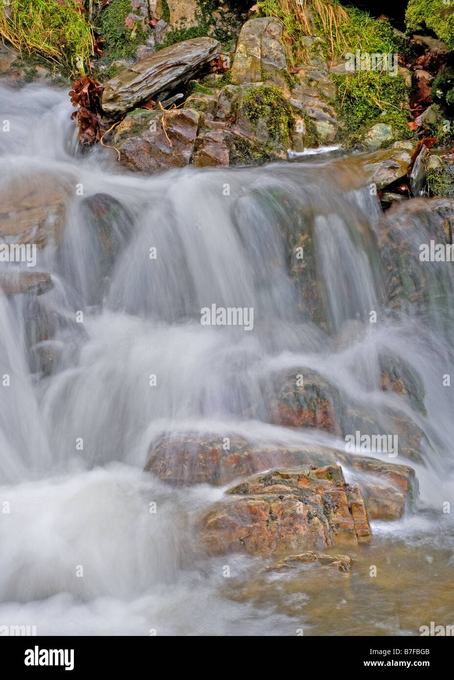 Waterfall cascadeing over rocks Stock Photo - Alamy