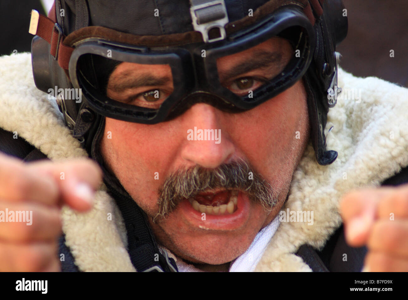 Man performs in the role of a 1940's style pilot in a street ...