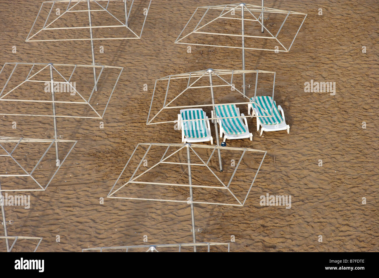 Aerial view of unclothed umbrella carcasses and reclining chairs on ...