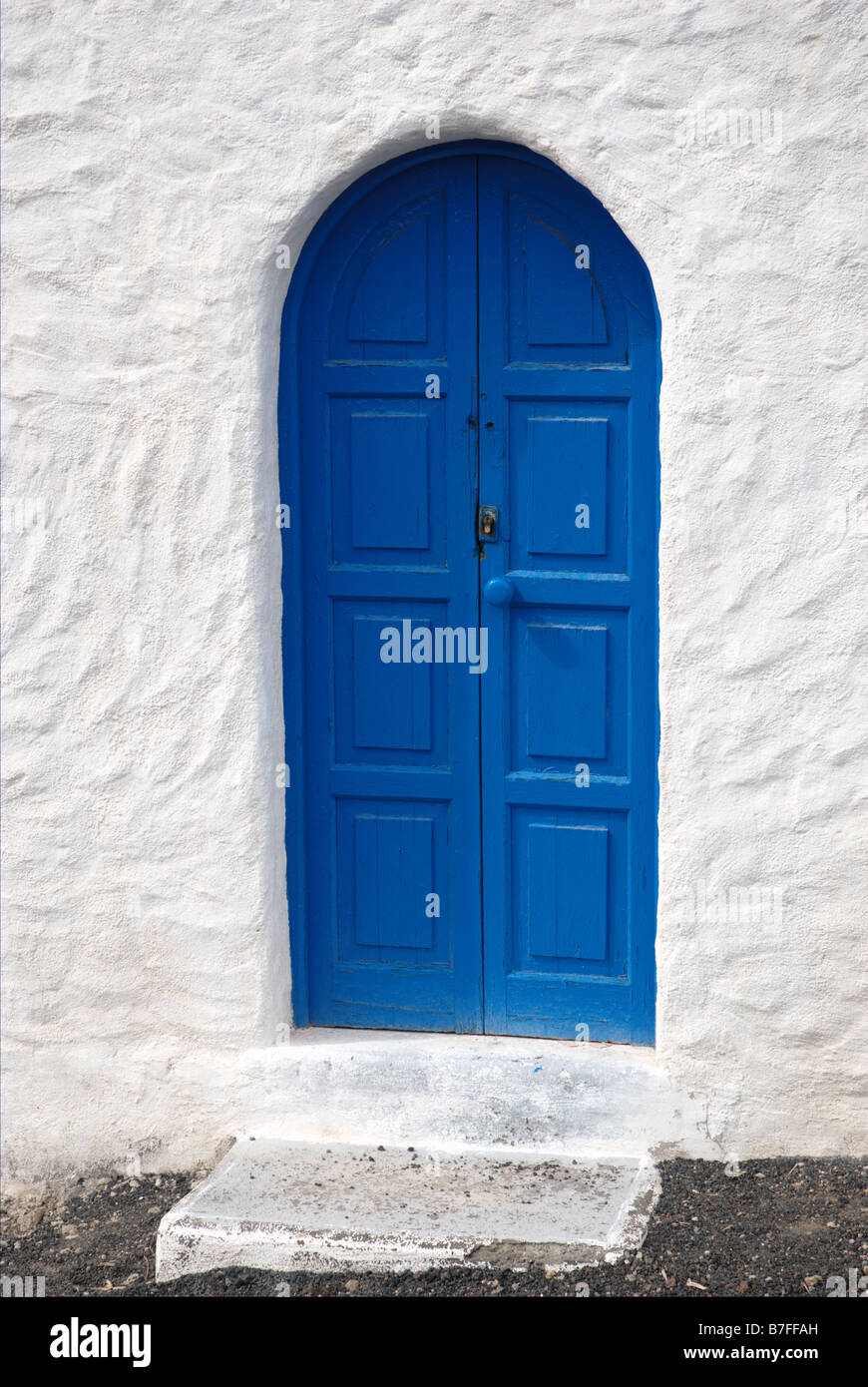 White washed building with a bright blue door in Lanzarote Canary ...
