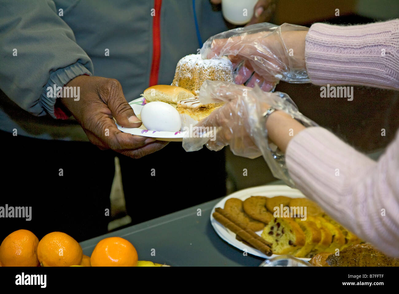 Volunteers Serve Breakfast to Homeless Men Stock Photo - Alamy