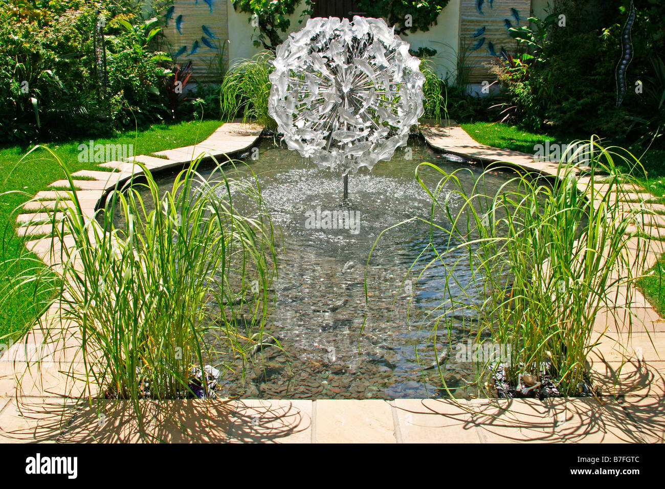 MODERN WATER FEATURE WITH FOUNTAIN BASED ON GLASS FISH Stock Photo - Alamy