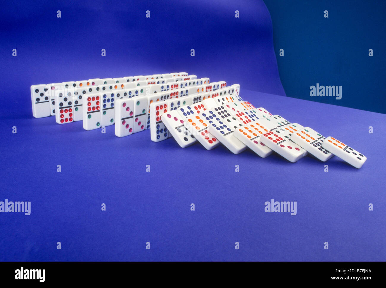 dominos fall increasing size of row each time Stock Photo - Alamy