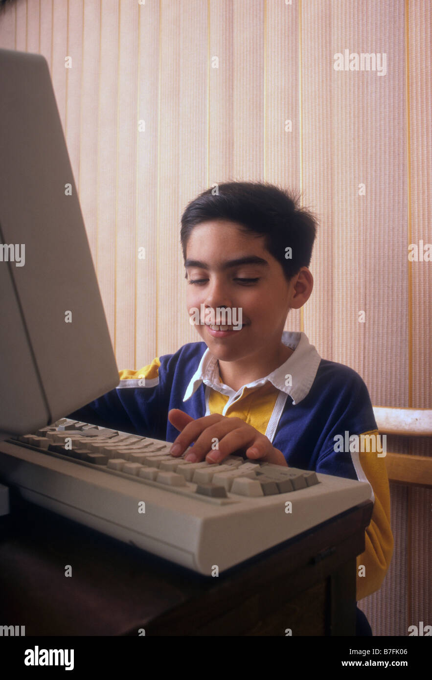 Young Hispanic boy works on computer Stock Photo - Alamy