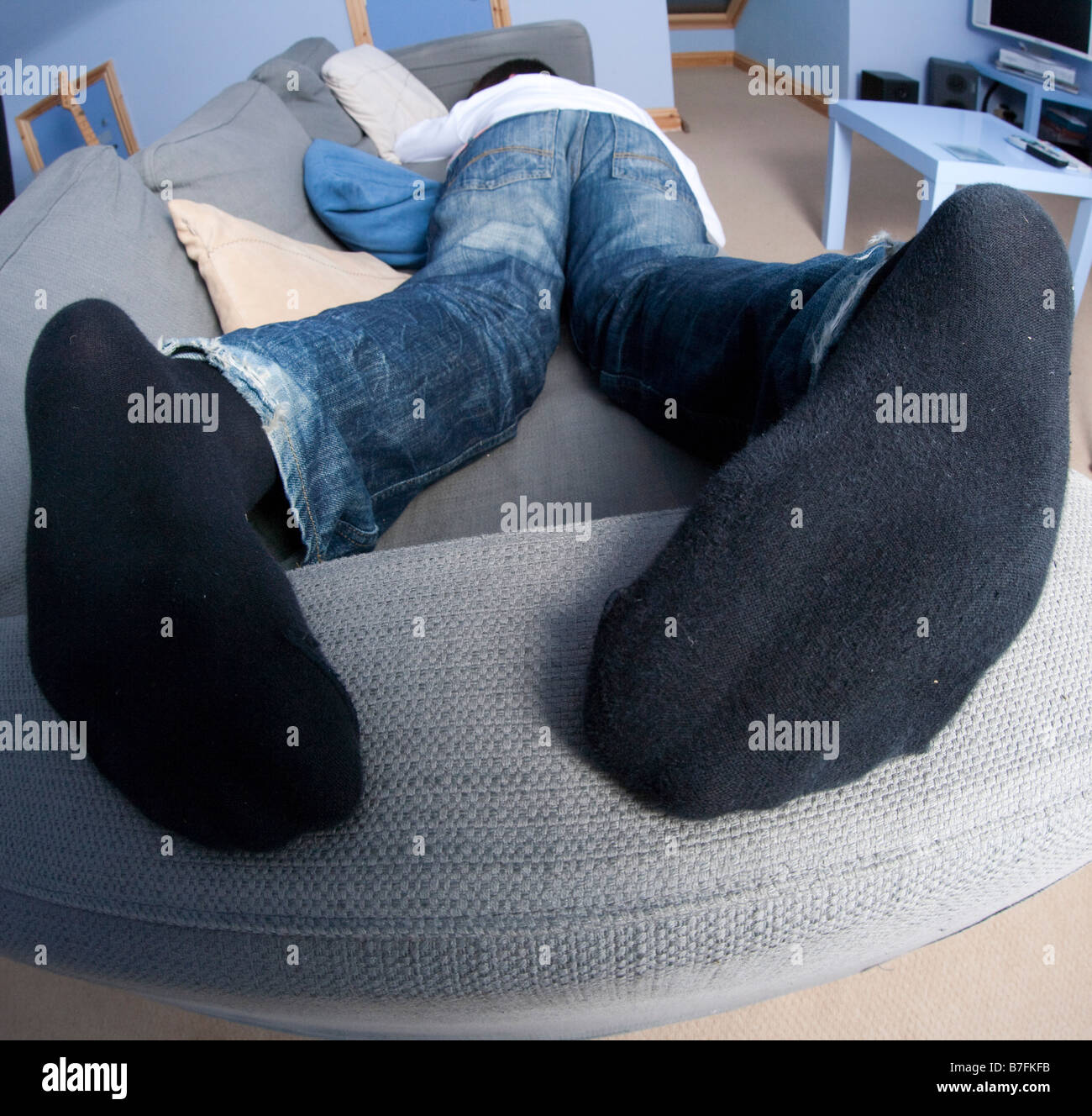 teenage boy sleeping on couch Stock Photo - Alamy