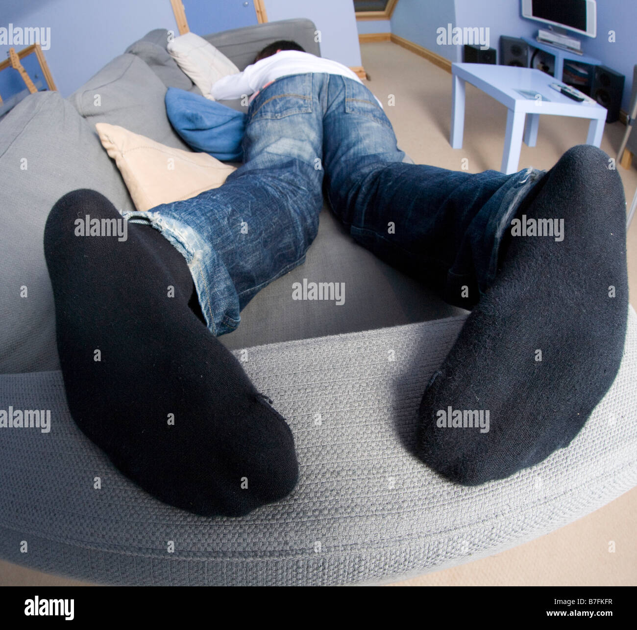 teenage boy sleeping on couch Stock Photo - Alamy